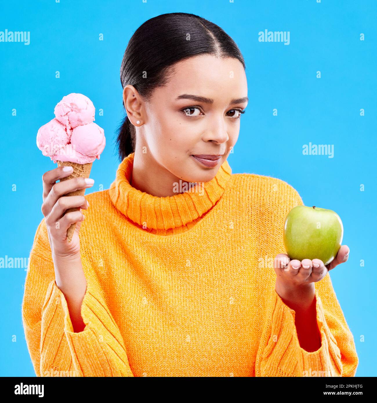 Woman, ice cream and apple with choice in portrait for health, wellness and diet by blue ...