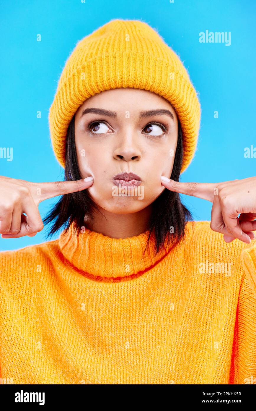 Silly, goofy and young woman in a studio with a comic, funny and crazy ...