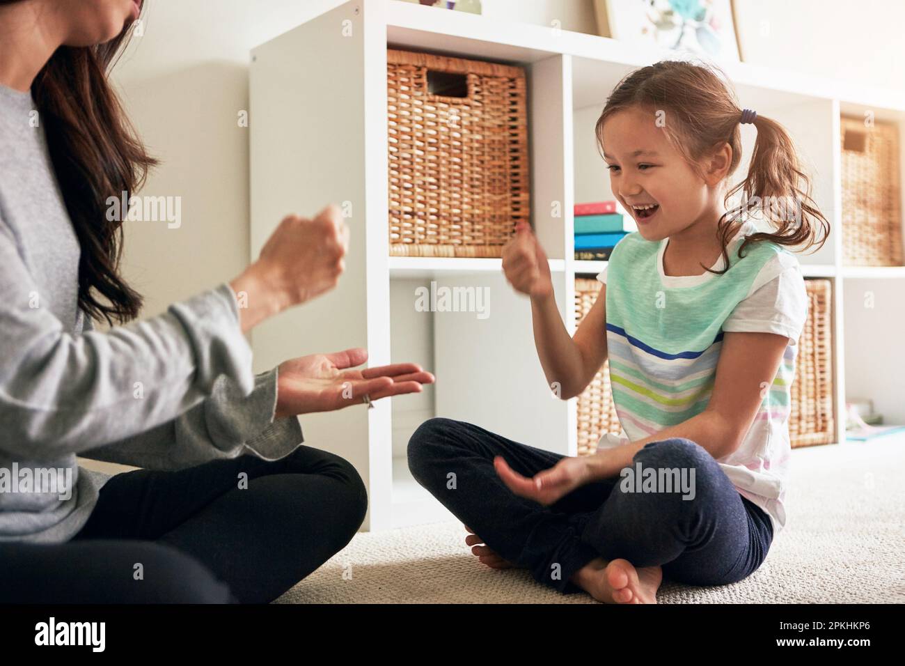 Rock, paper, scissors. a little girl playing rock, paper, scissors with ...