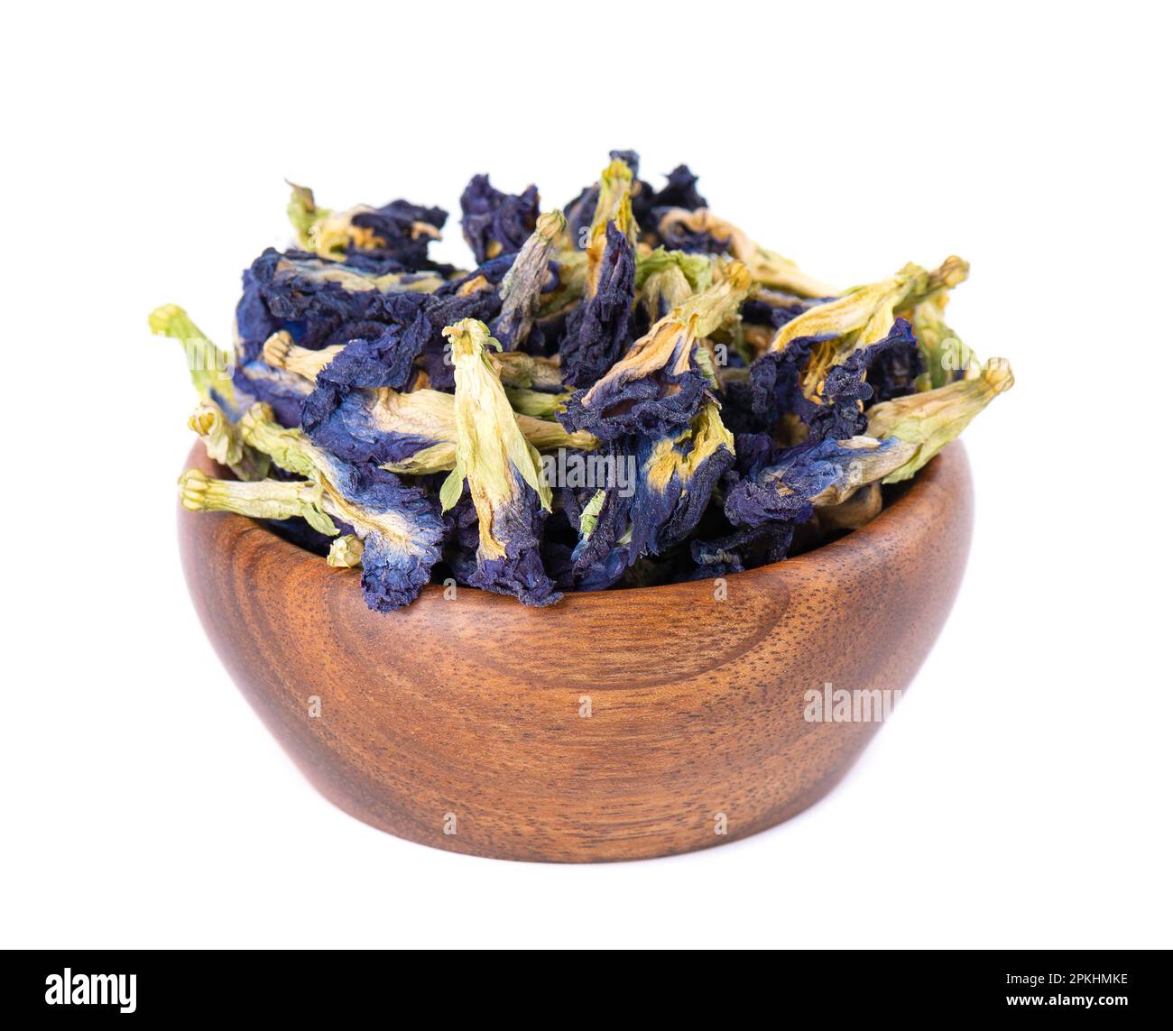 Butterfly pea flowers in wooden bowl, isolated on white background ...