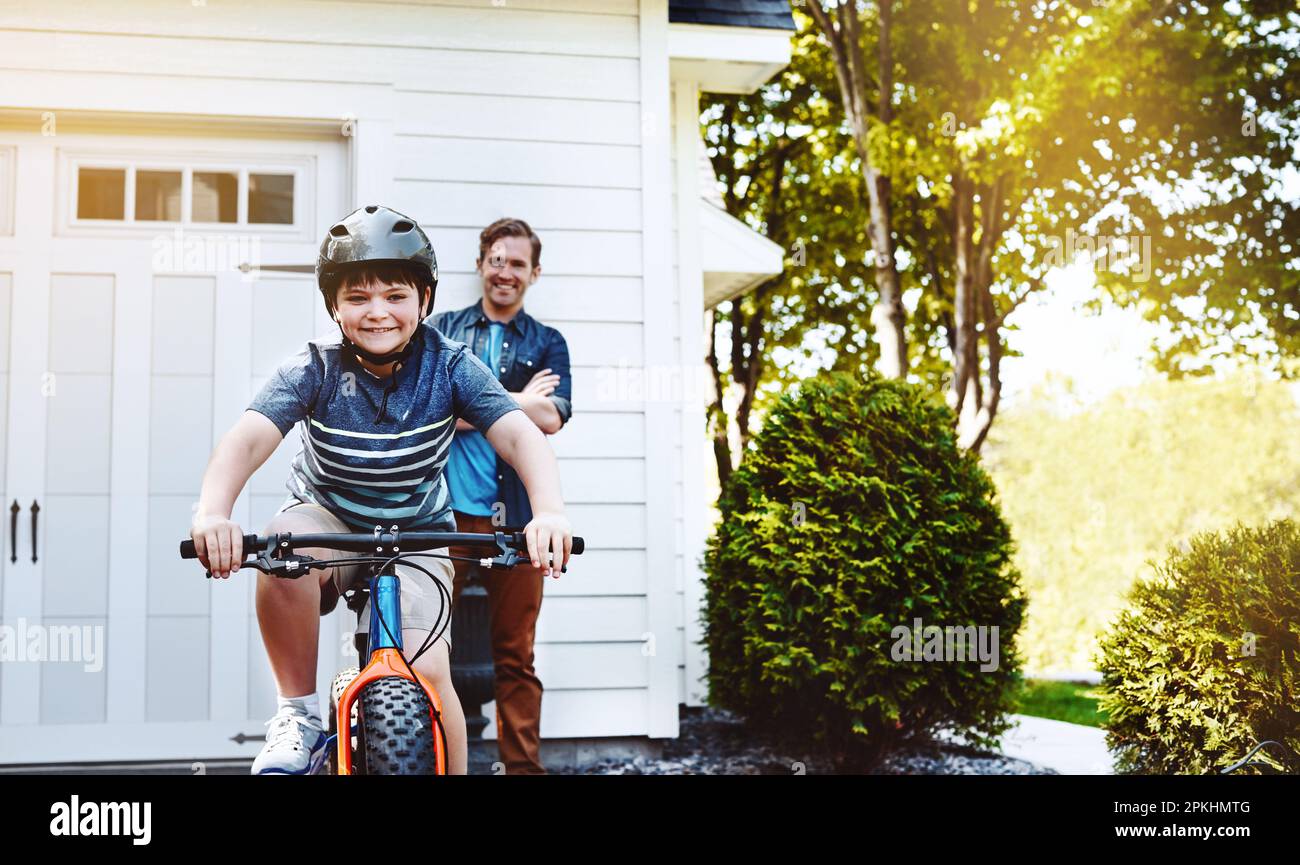 Look Dad No more training wheels. a young boy riding a bicycle with his ...