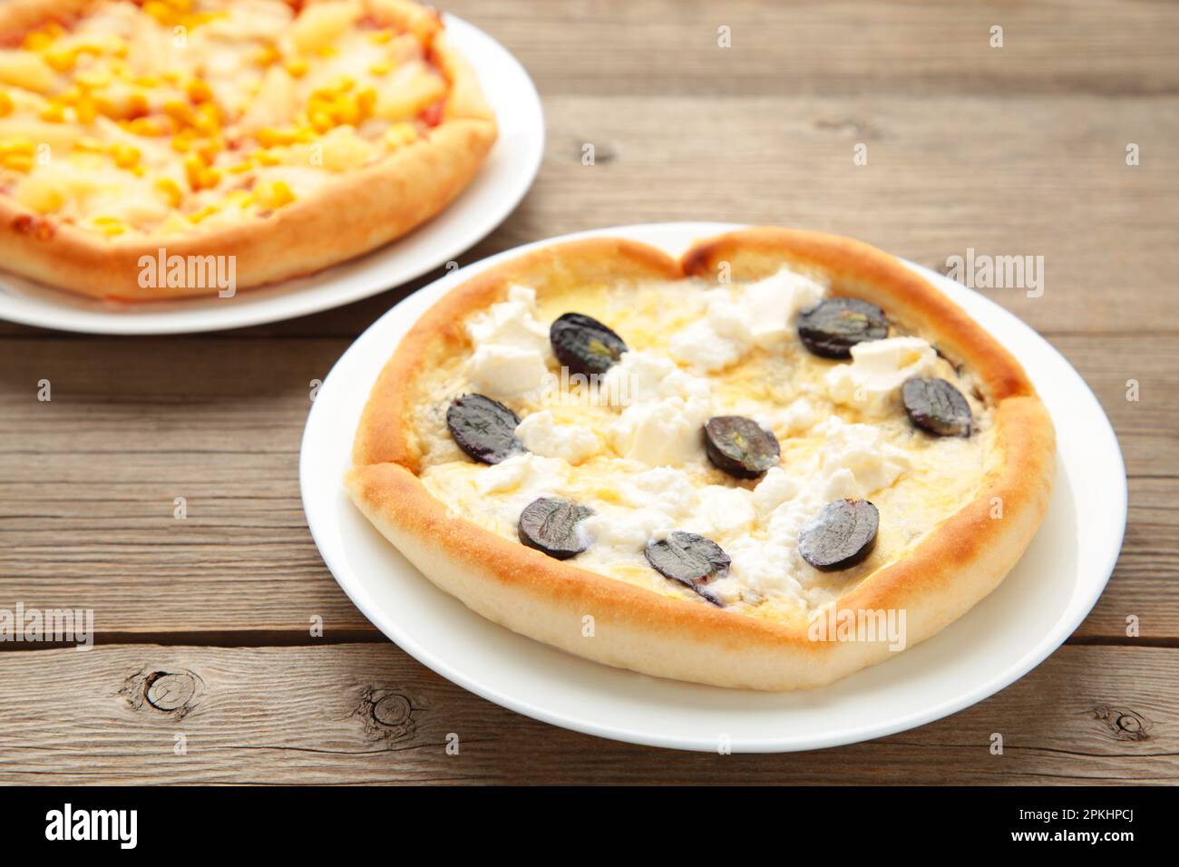 Delicious italian pizzas on grey wooden table. Top view Stock Photo - Alamy