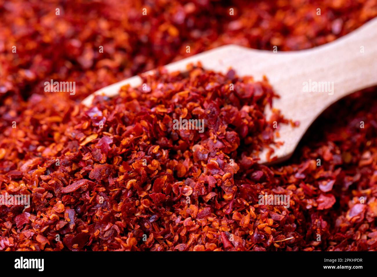 Chilli pepper seedless flakes. Heap of dried red pepper flakes with ...