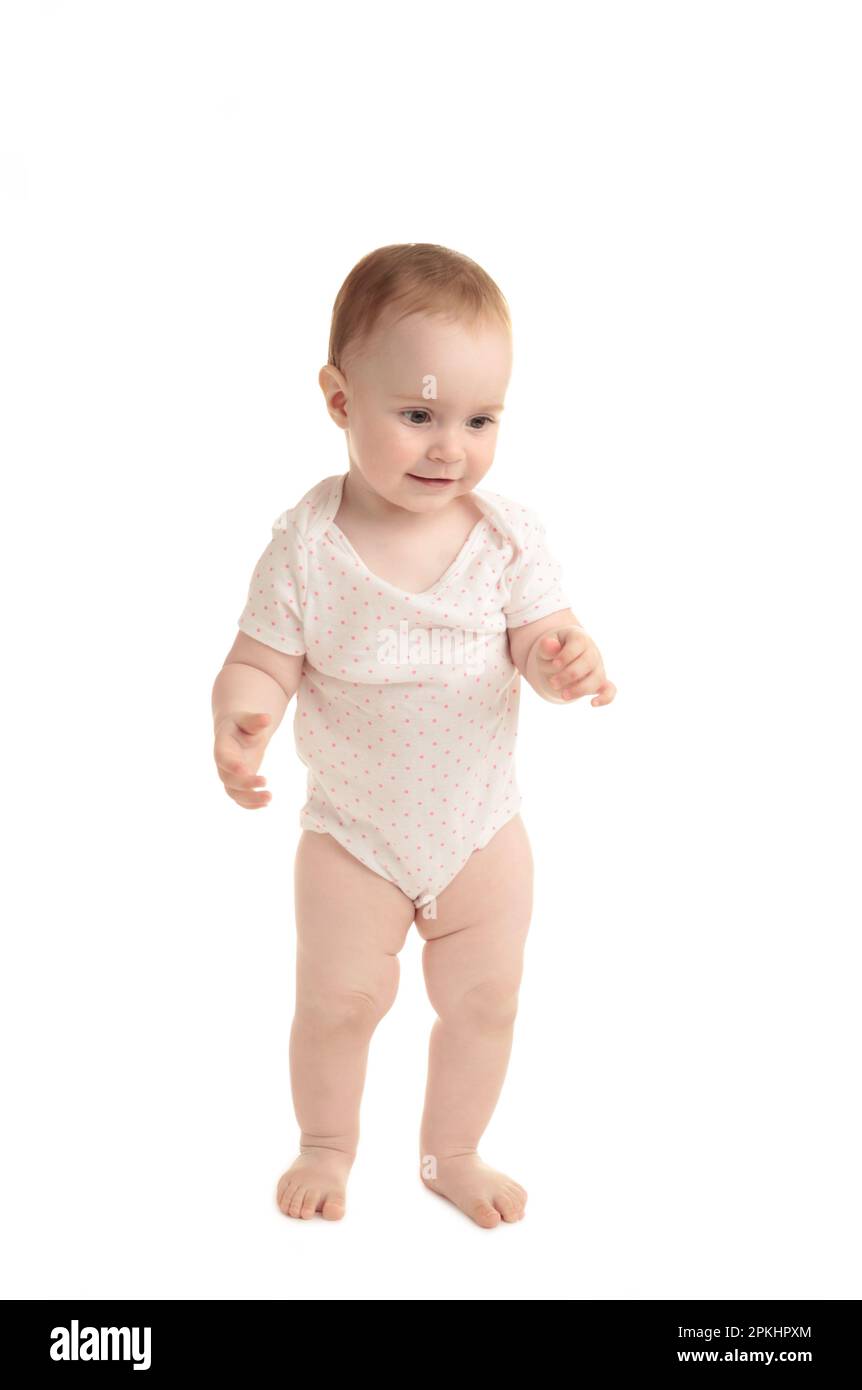 Smiling child walking isolated on white background. Baby's first steps ...