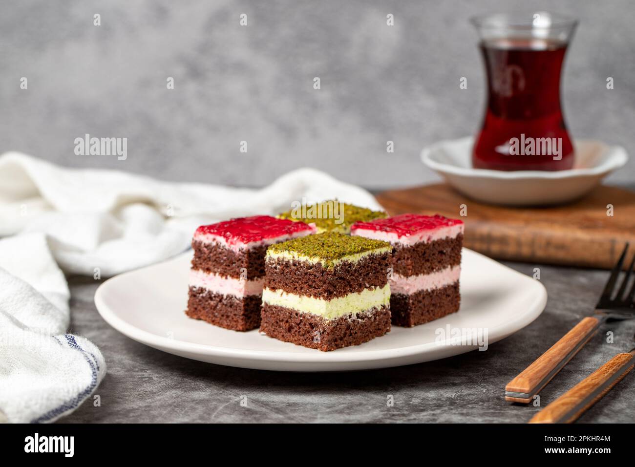 Small cake slices. Pistachio and raspberry cake slices. Set of ...