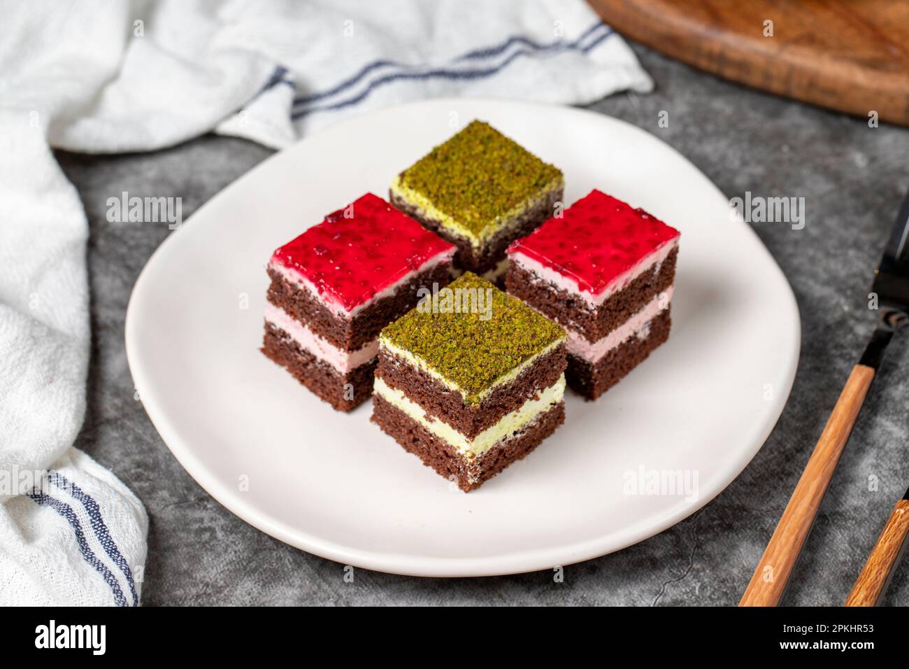 Small cake slices. Pistachio and raspberry cake slices. Set of ...