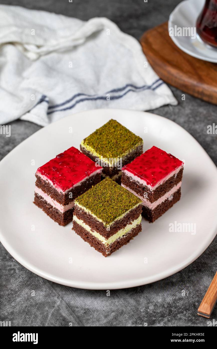 Small cake slices. Pistachio and raspberry cake slices. Set of ...
