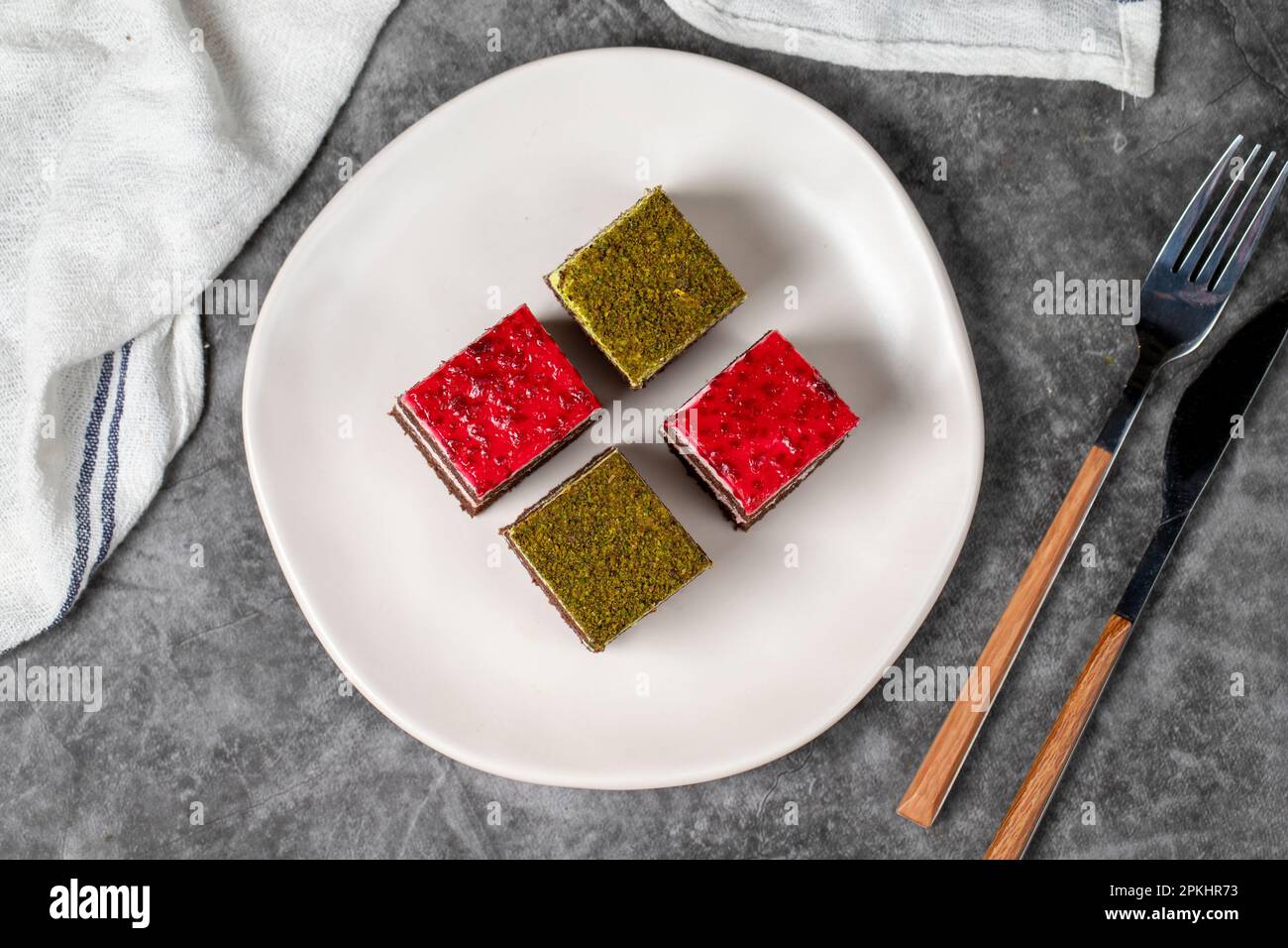 Small cake slices. Pistachio and raspberry cake slices. Set of ...