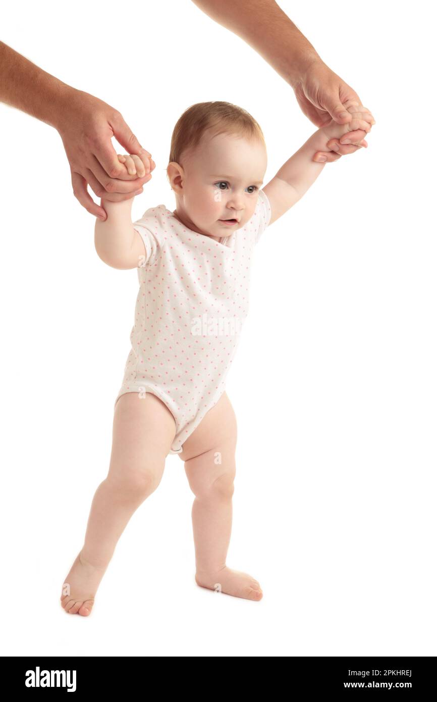 Smiling child walking hand in hand with father on white background ...