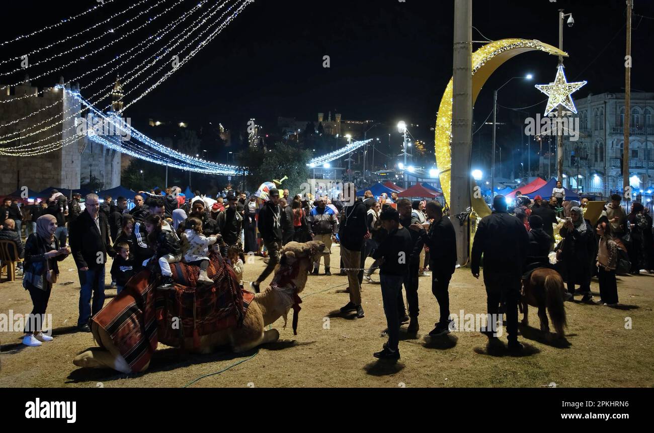 Children ride a camel as Palestinians gather in front of Damascus Gate ...