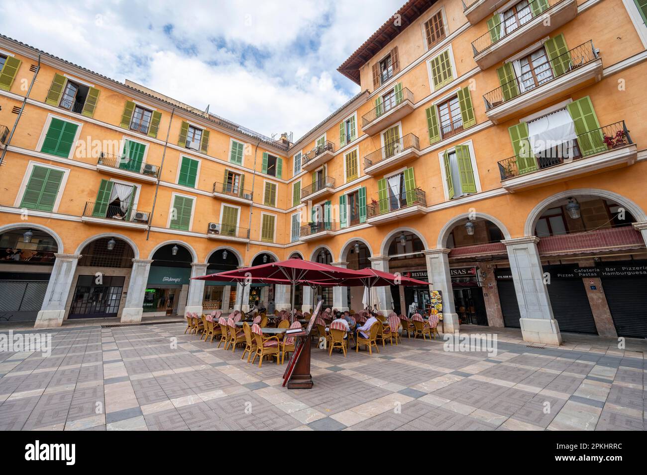 Yellow facade with arcades, restaurant in Placa Major, Palma de Majorca ...