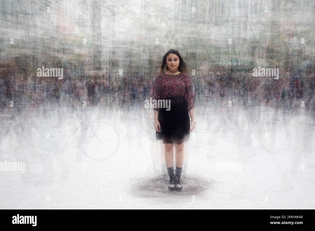 young asian woman standing still amidst a busy crowd of fast moving ...
