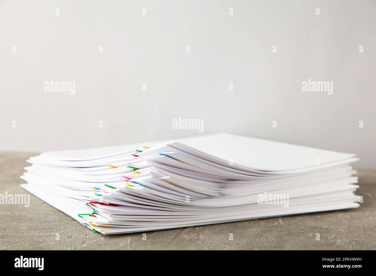 Stack of white paper with clips on grey background. Top view Stock ...