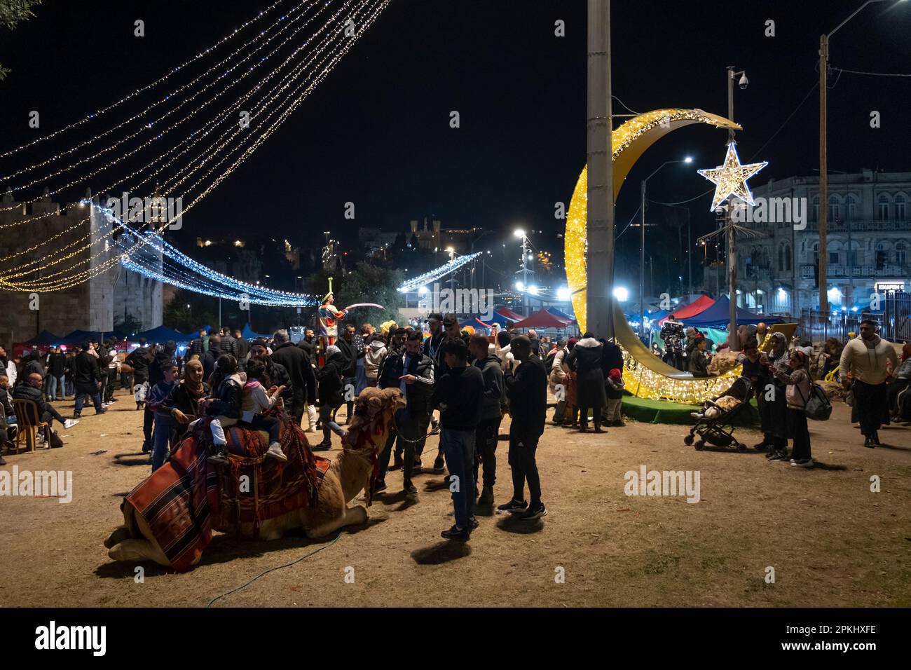 Children ride a camel as Palestinians gather in front of Damascus Gate ...