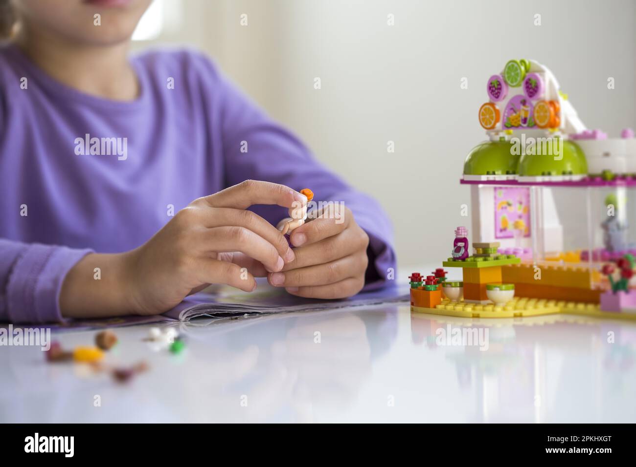 Girl (7) building a house out of Lego bricks, Kiel, Schleswig-Holstein ...