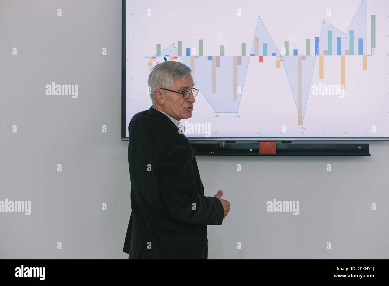 Close up of older business man presenting and explaining something ...
