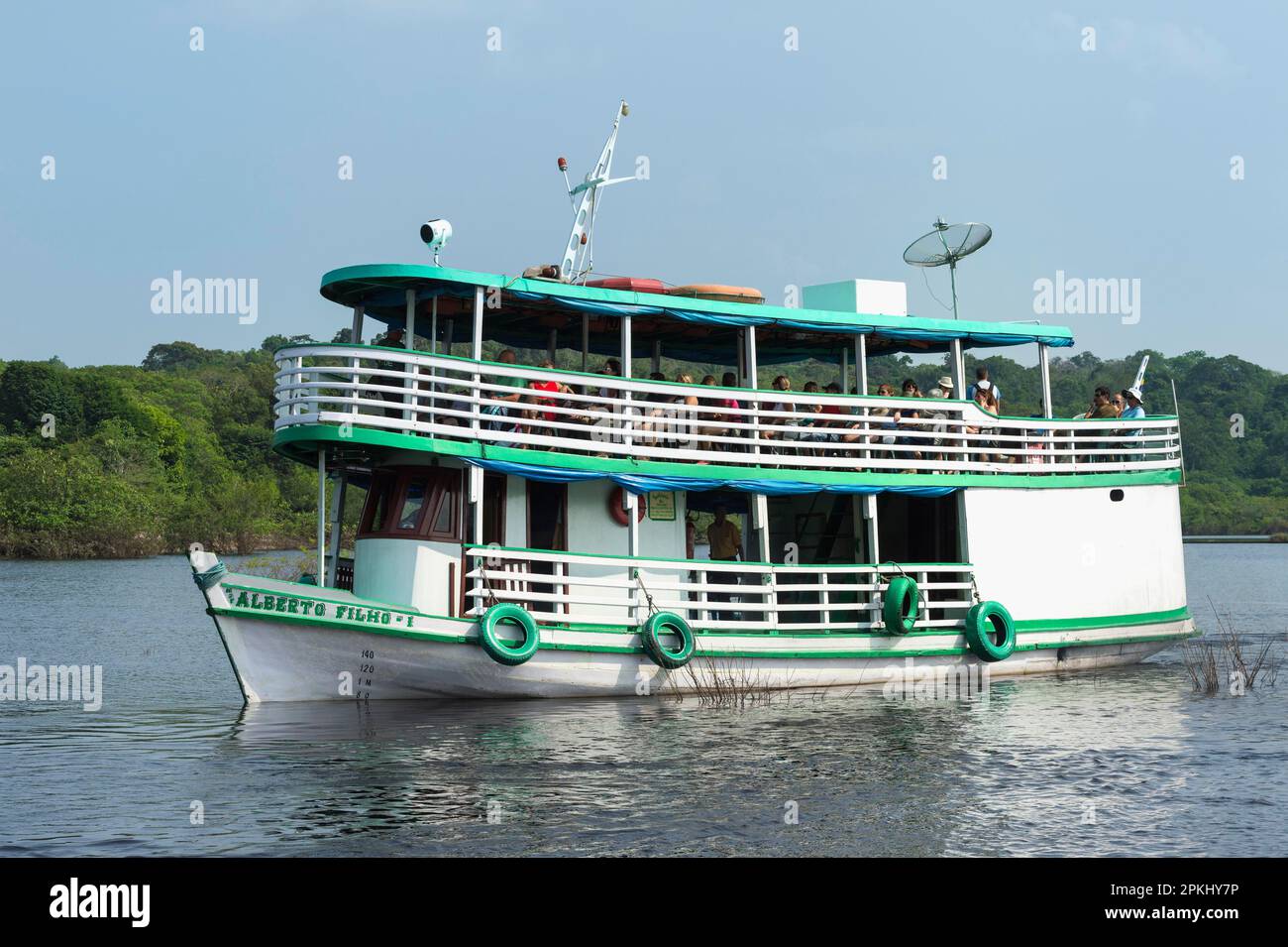 Traditional wood boat navigating with tourists on the Rio Negro, Manaus ...