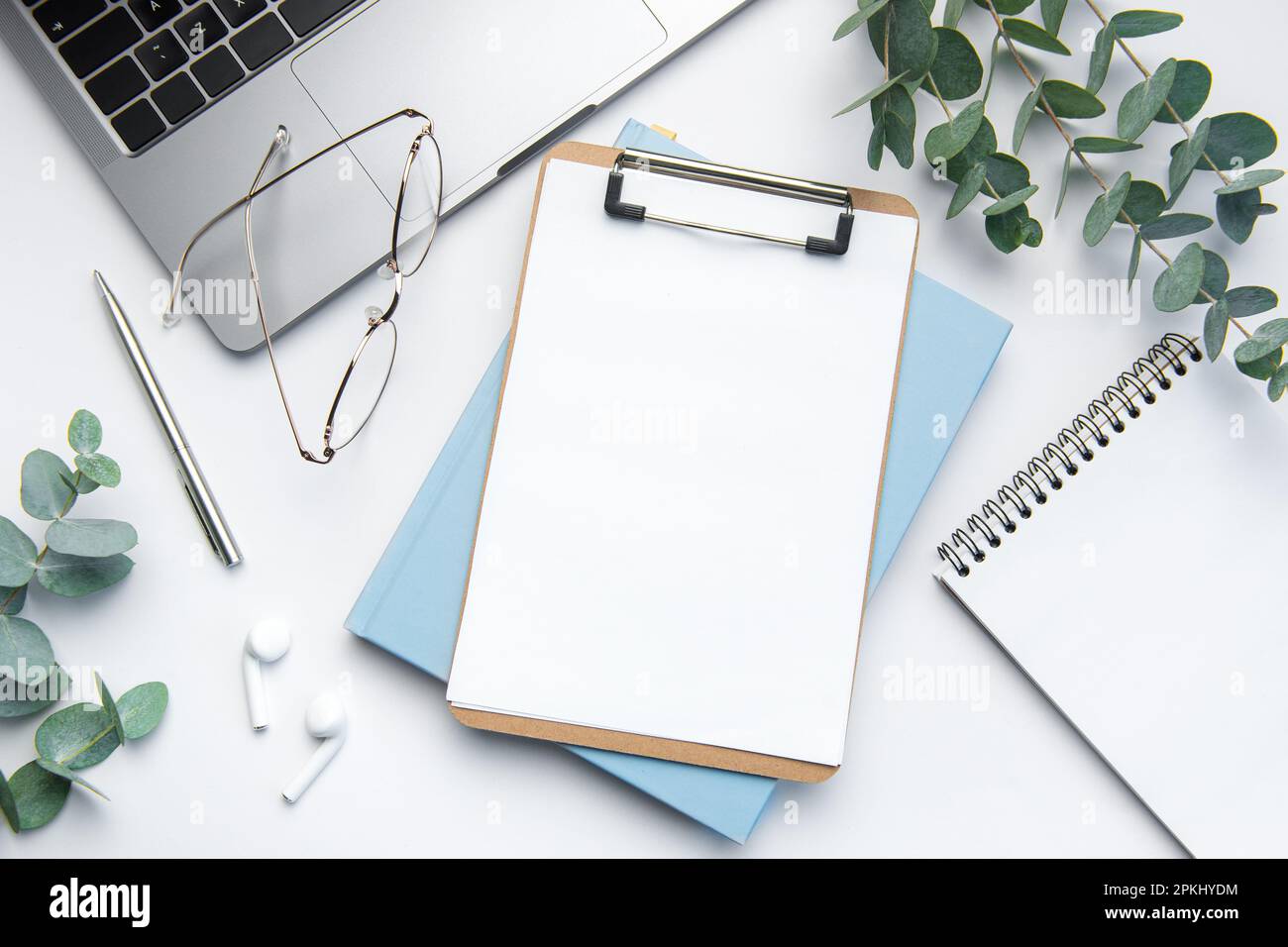 Modern white office desk table with laptop, notebook and other supplies ...