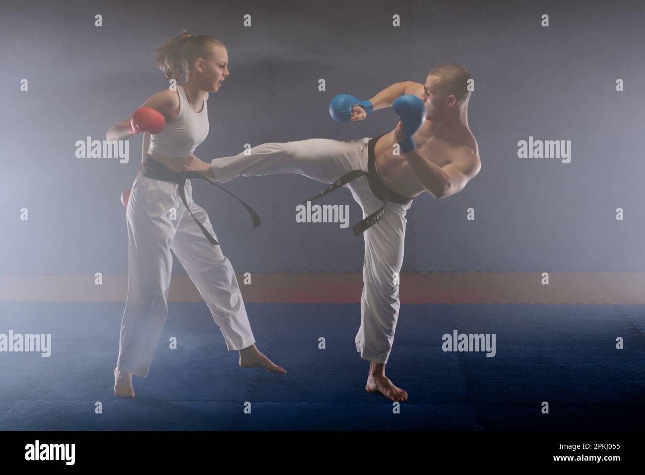 Close up of two young karate friends doing the Ushiro Kakato pose at ...