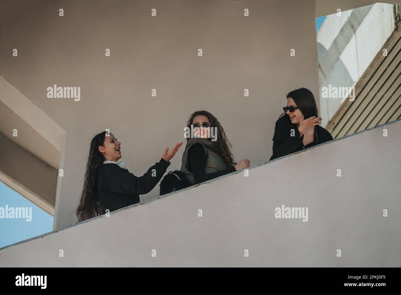 Three gorgeous female friends are about to go shopping. They are ...