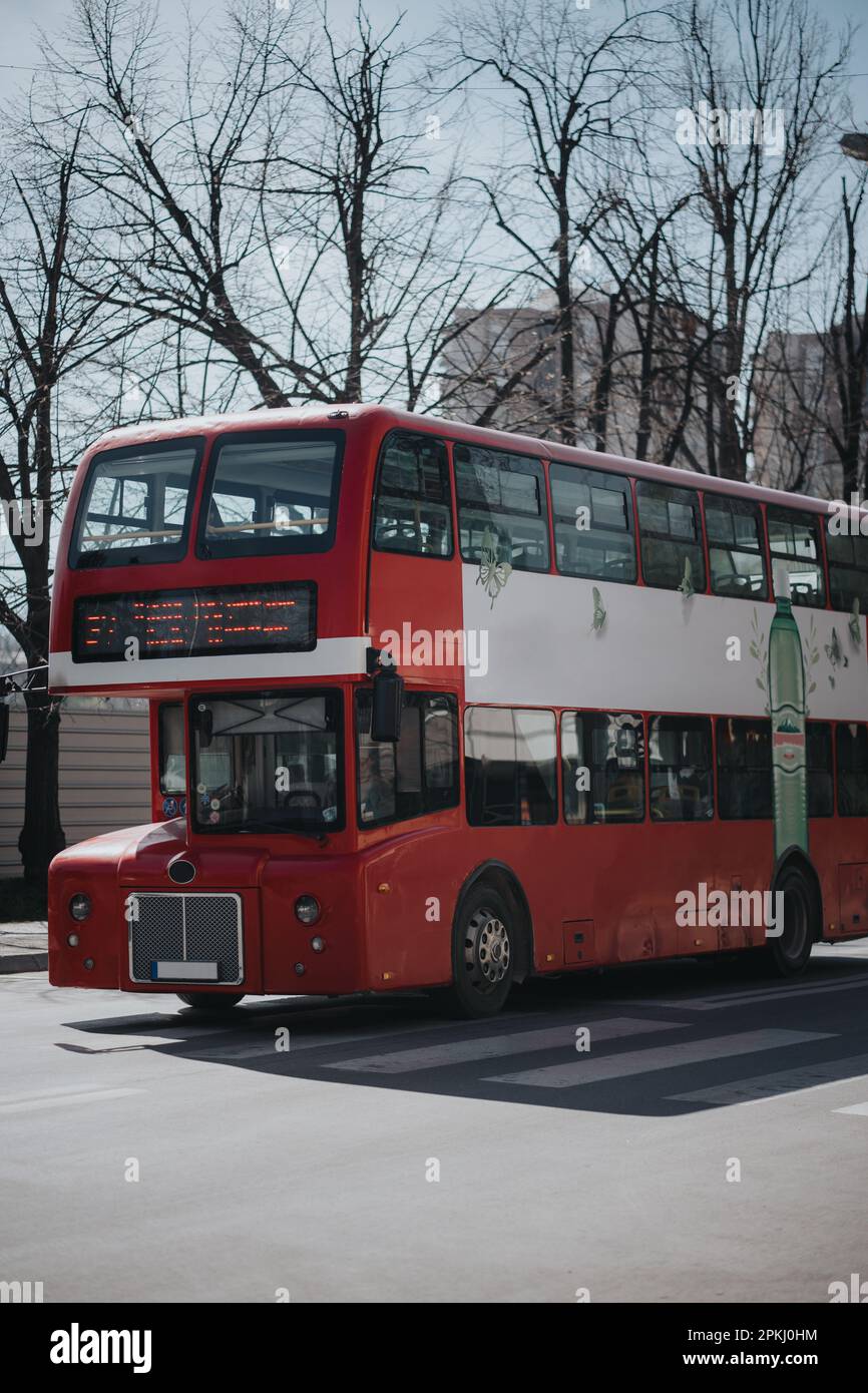 Driving big red bus on the street at the city center Stock Photo - Alamy