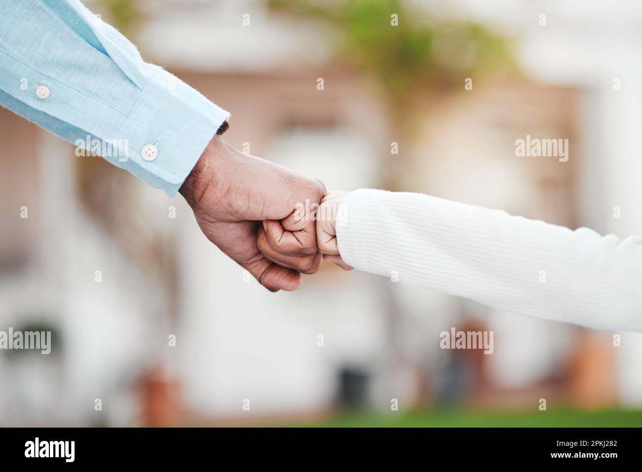 Adult, child and hands in fist bump for trust, agreement or partnership ...