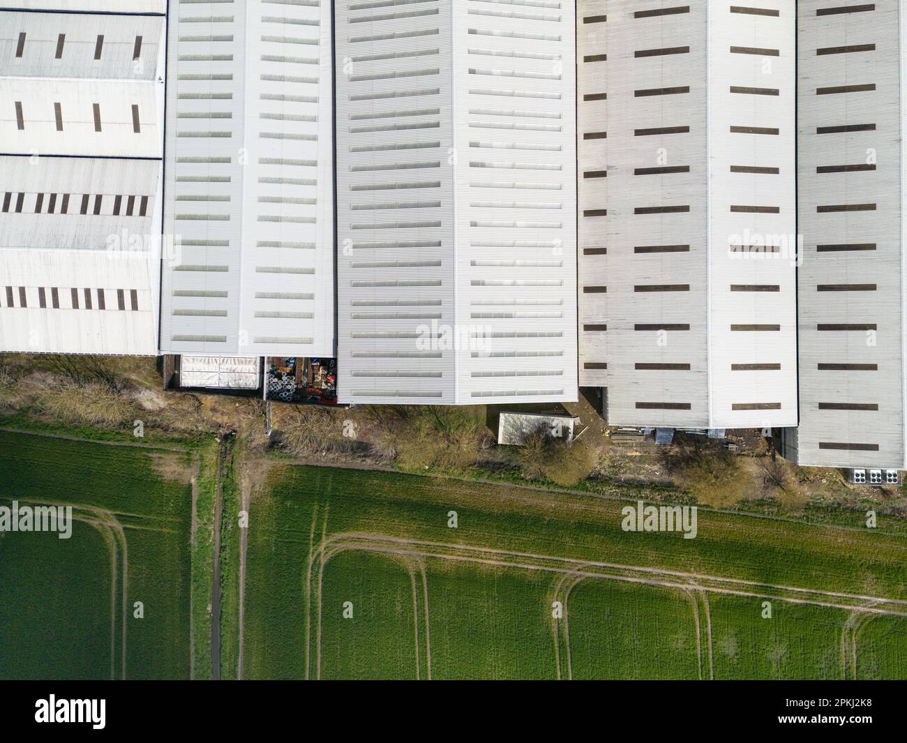 Drone top down view of a large warehouse facility seen at the edge of ...