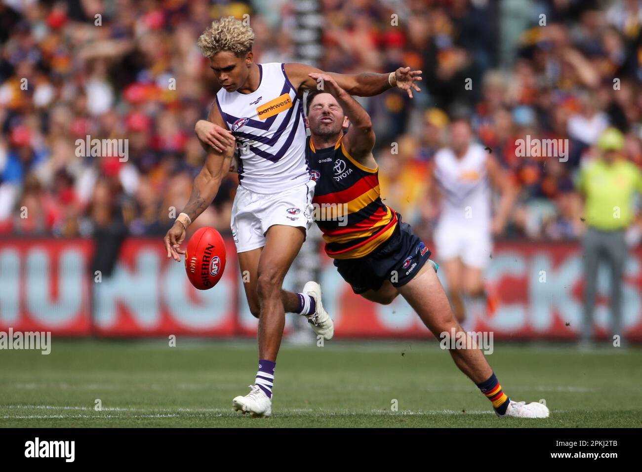 Liam Henry of the Dockers chased down by Chayce Jones of the Crows ...