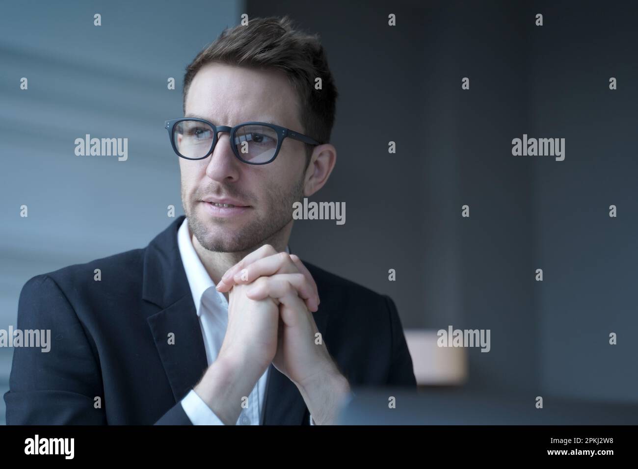Portrait of elegant German businessman in formal suit and glasses with ...