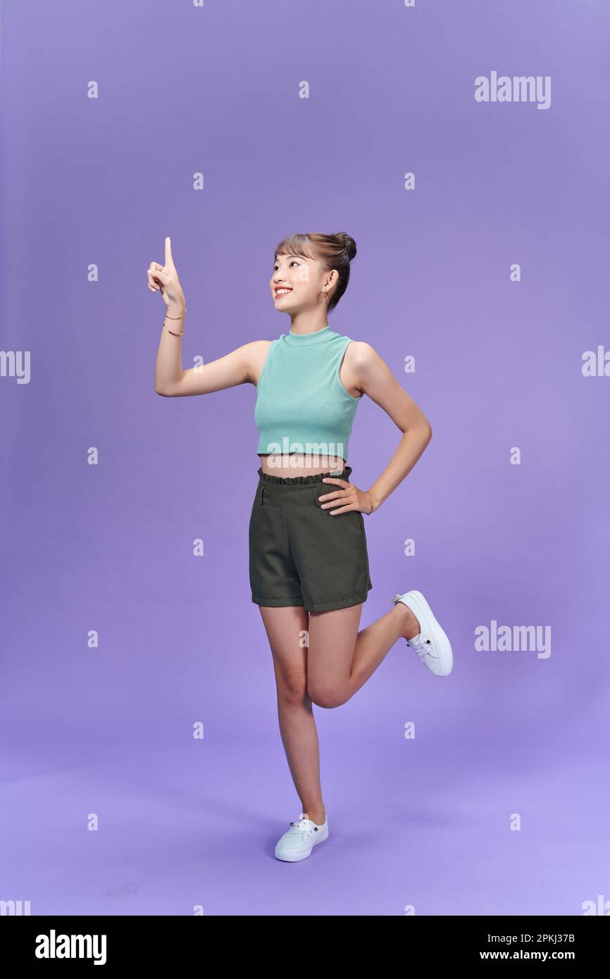 Photo of positive pretty lady jump two arm direct empty space isolated ...