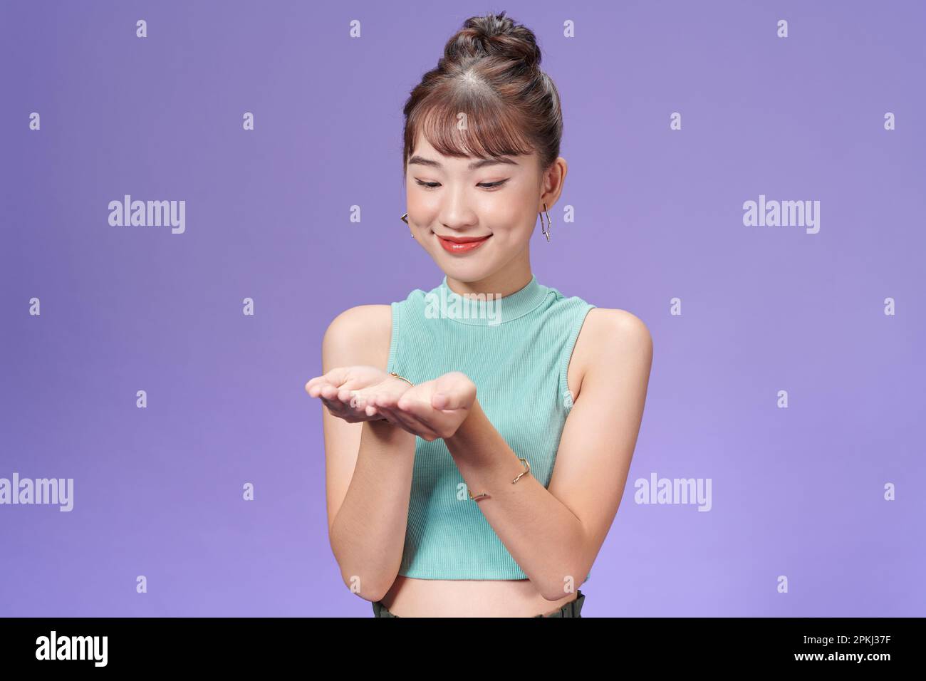 young excited woman standing happy smiling holding her hand showing ...
