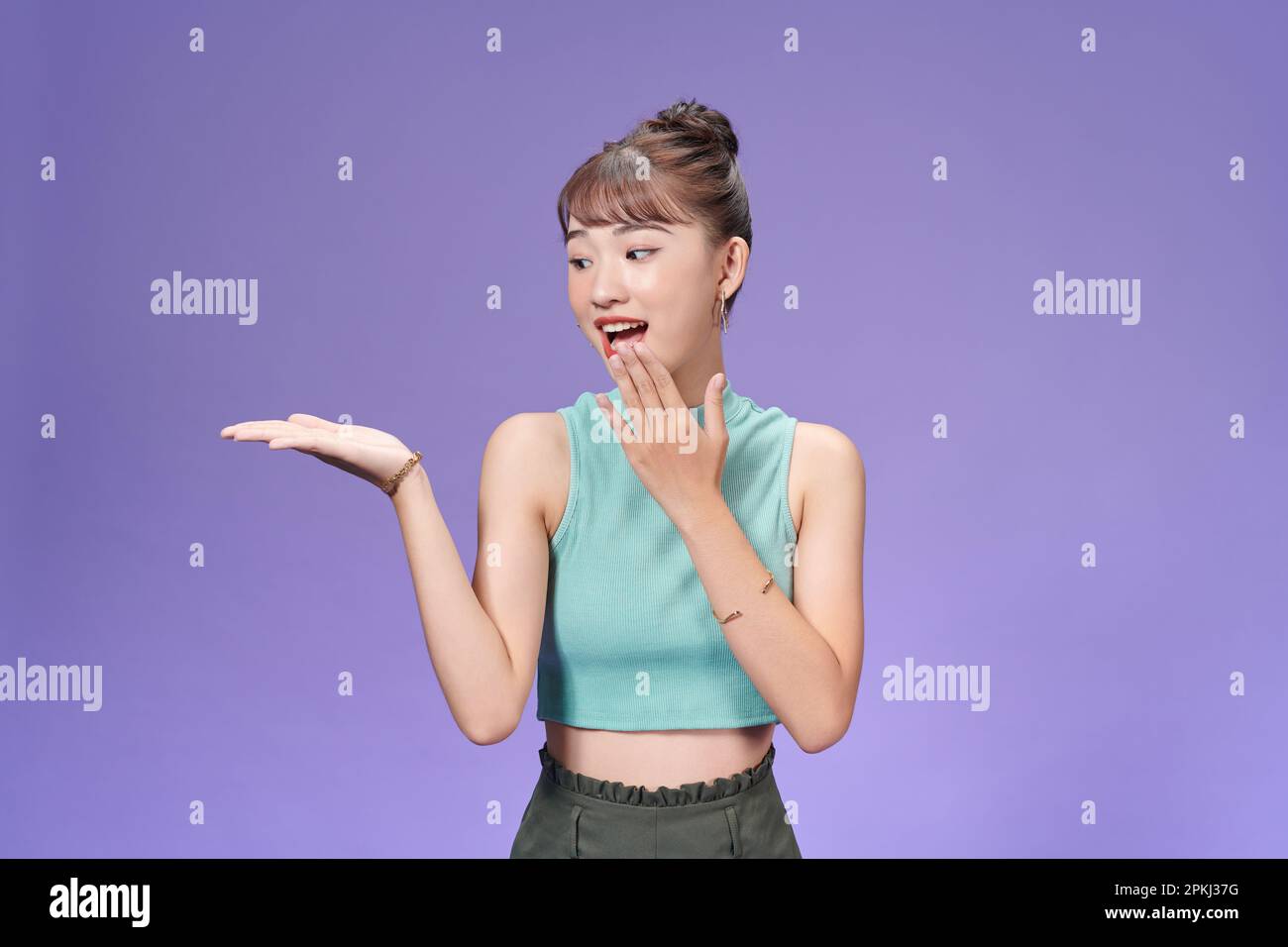 Attractive beautiful asian woman open hands palm up holding something ...