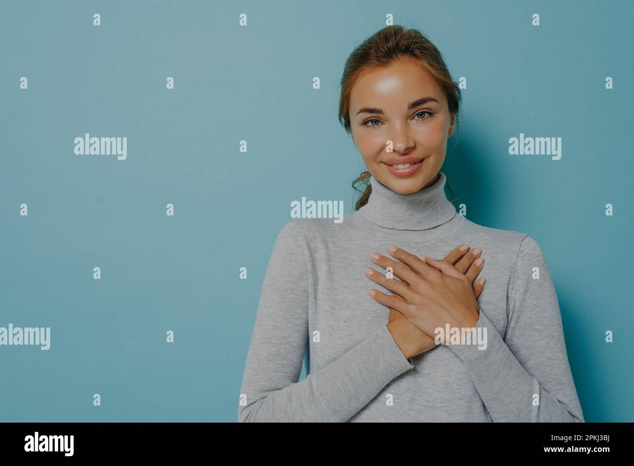 Hand on chest woman happy hi-res stock photography and images - Alamy