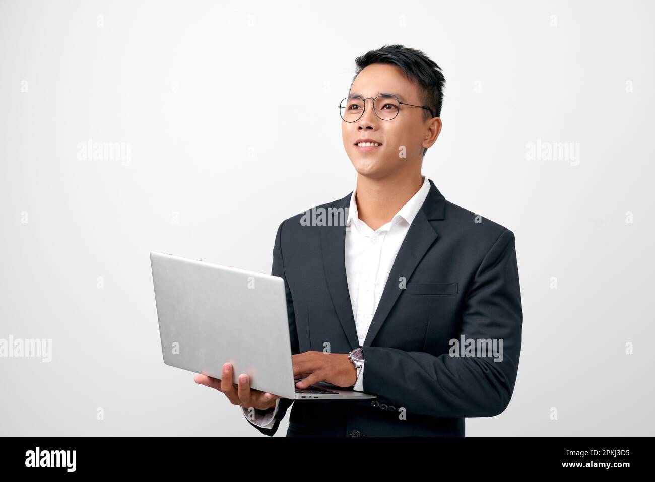 Smiling young man standing in black suit and glasses, holding open ...