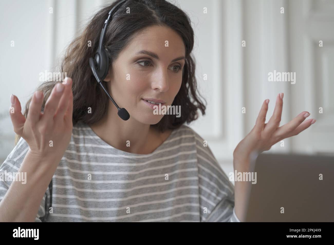 Confident focused young spanish businesswoman wearing wireless ...