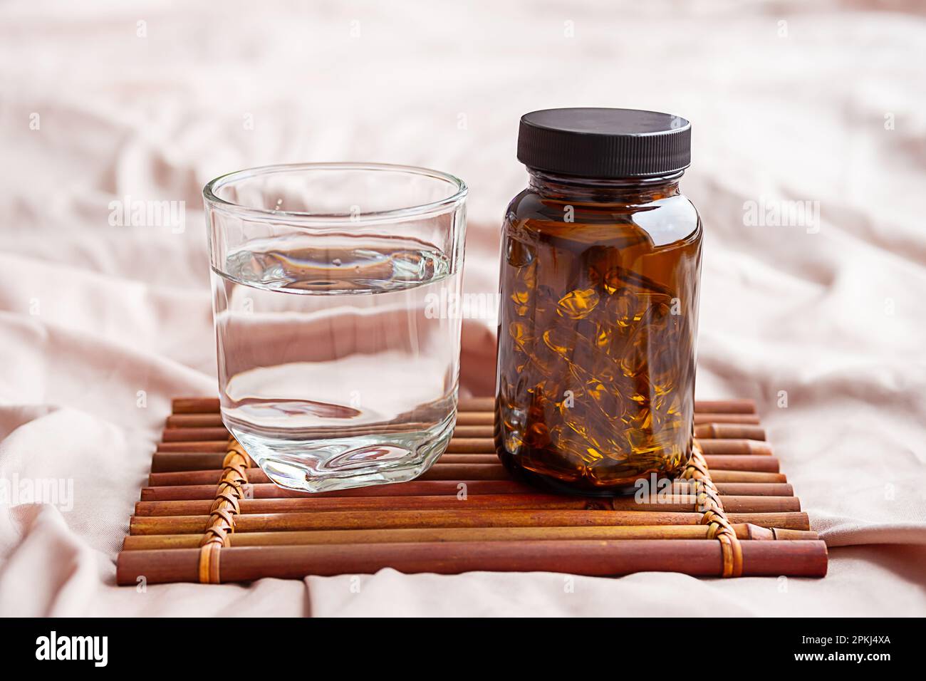 Omega 3 oil capsules and water glass on tray. Fatty acids nutritional ...