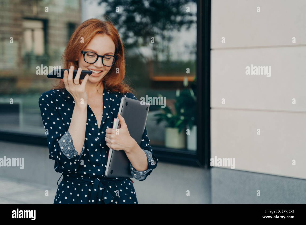 Beautiful Redhead Female Entrepreneur Walks Outdoor Records Voice Message In Social Media Via