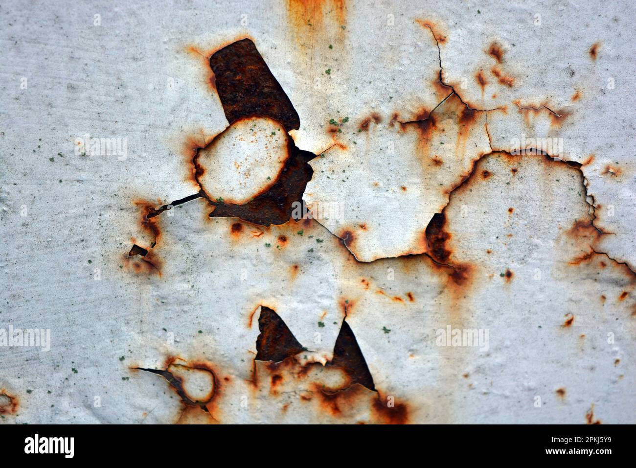 An old conquered metal gray door with guns, rust, peeling paint and ...