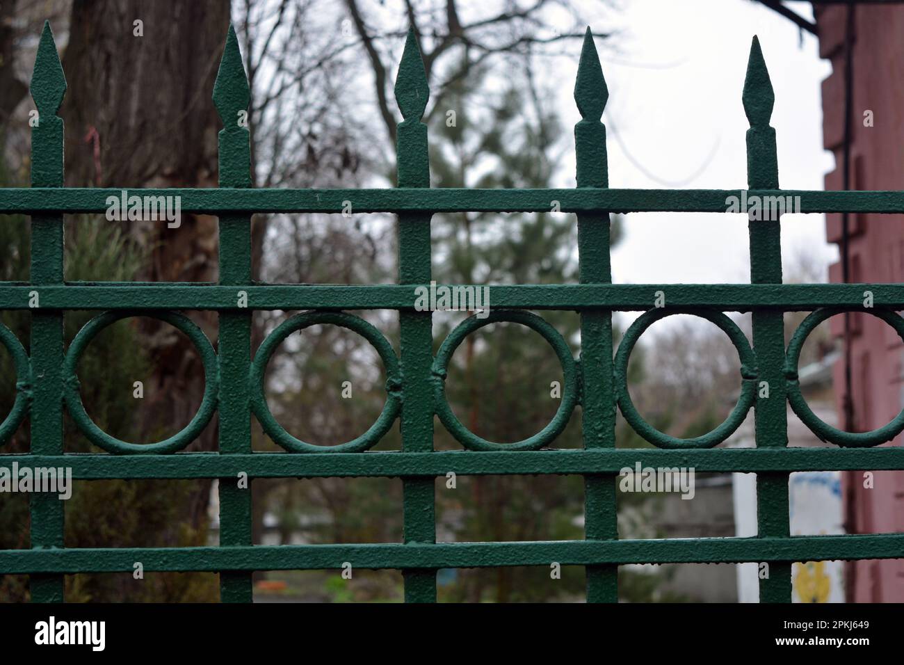 An old forged, metal fence with pikes, pins, rings from Soviet times ...