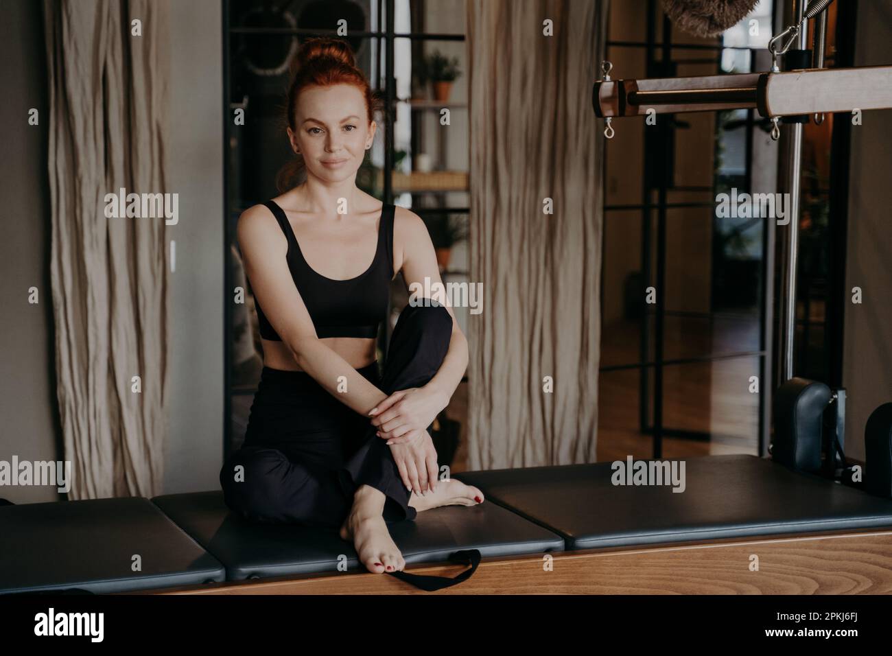 Beautiful ginger woman in sportswear sitting on Cadillac machine with ...