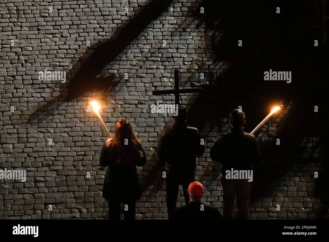 Faithful hold the cross as they take part in the Via Crucis (Way of the ...