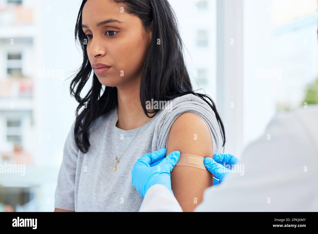 Scared woman, arm and covid with a plaster and doctor for healthcare ...