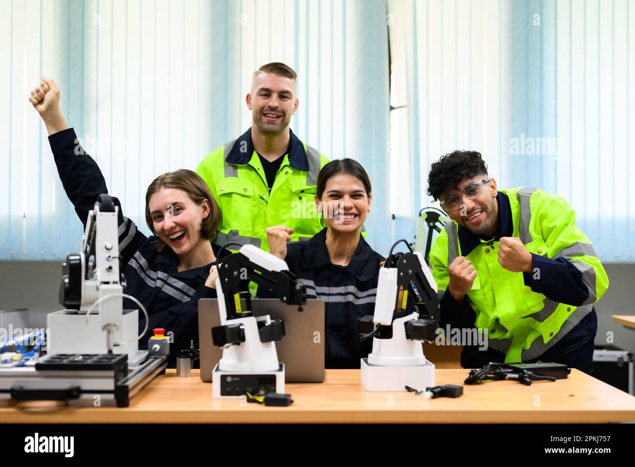 Group of industrial engineers working with robot maintenance Stock ...
