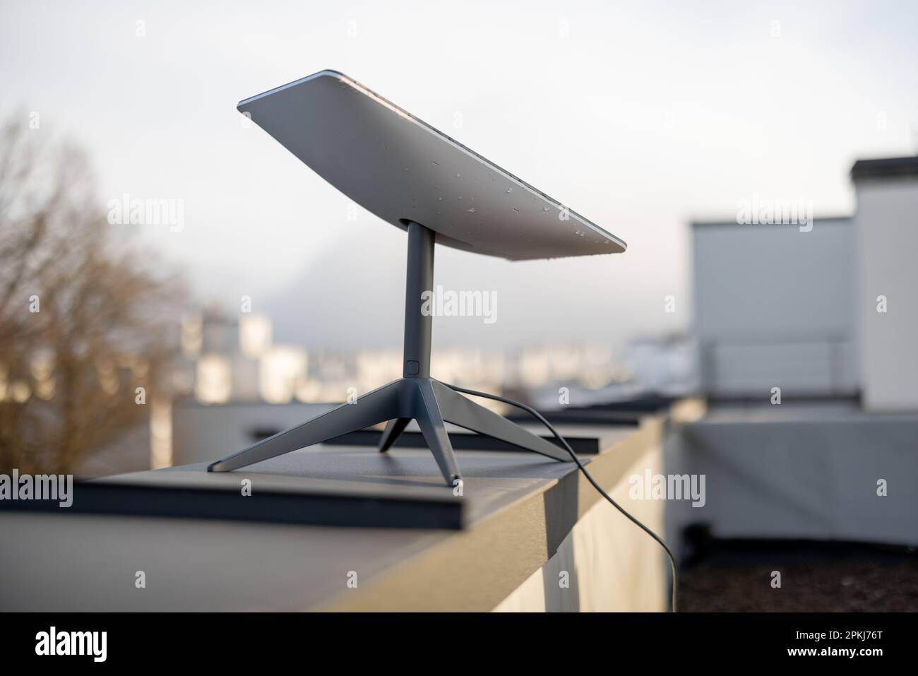 Starlink satellite dish on roof of residential building Stock Photo - Alamy