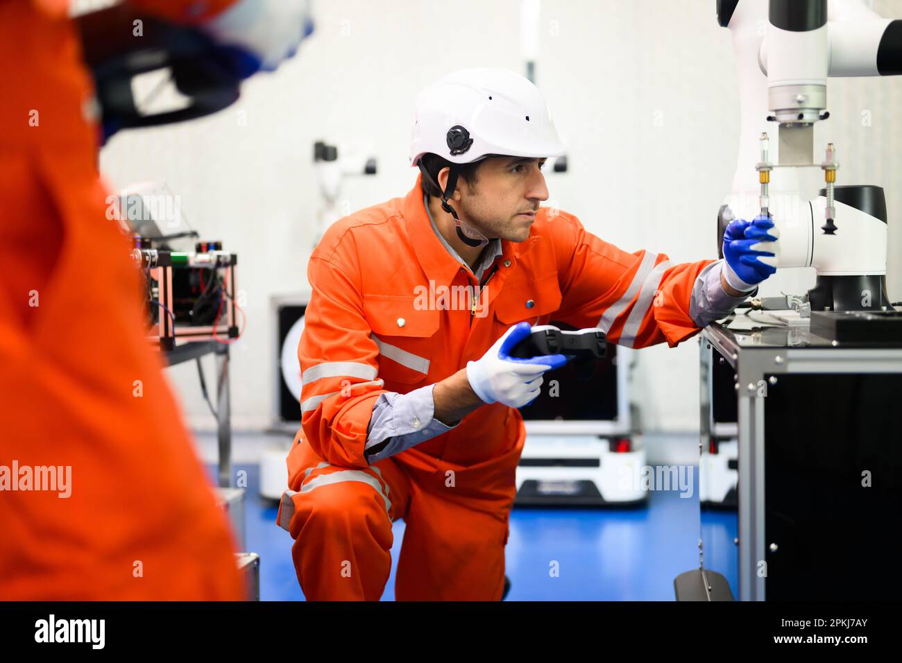 Robotics controller engineers working and solving problems on machine ...