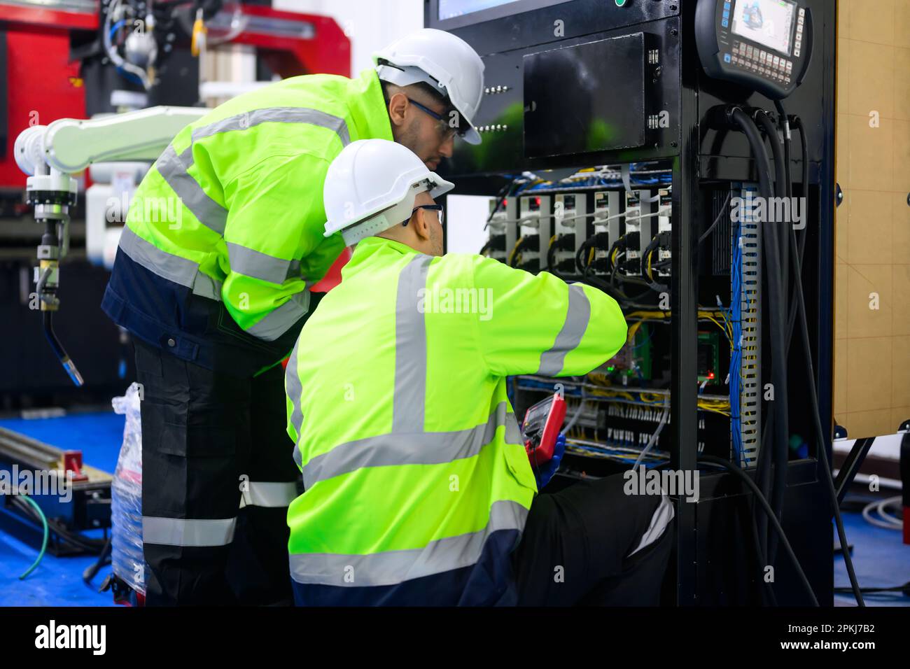 Electrician working with terminal power cable and controlled equipment ...