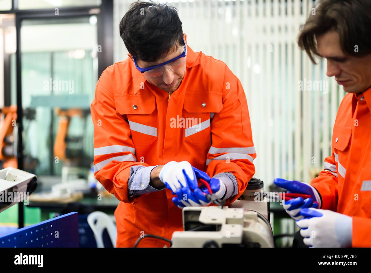 Engineers working and solving problems on machine at industrial plant ...