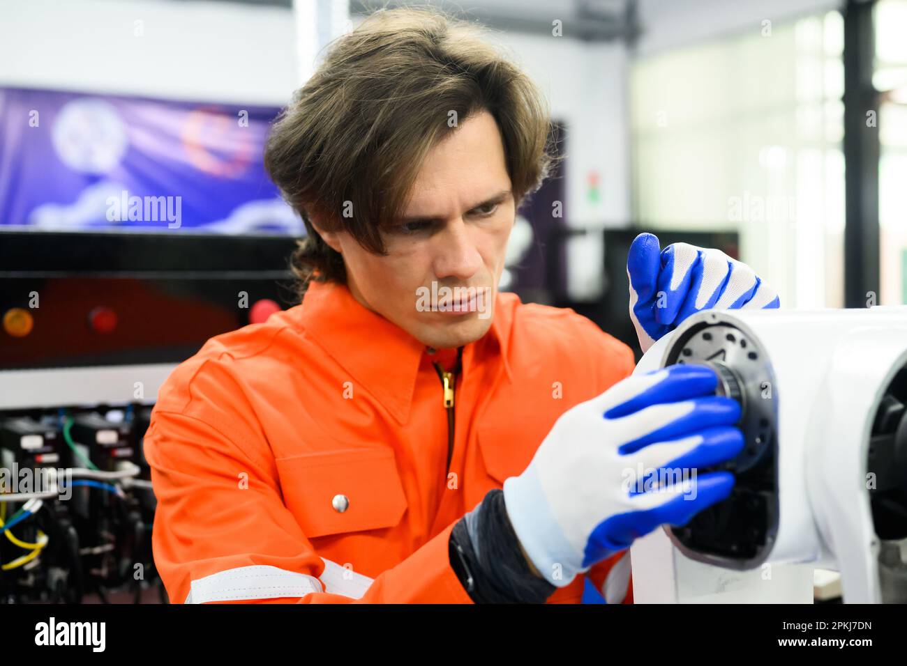 Engineer working and solving problems on machine at industrial plant ...