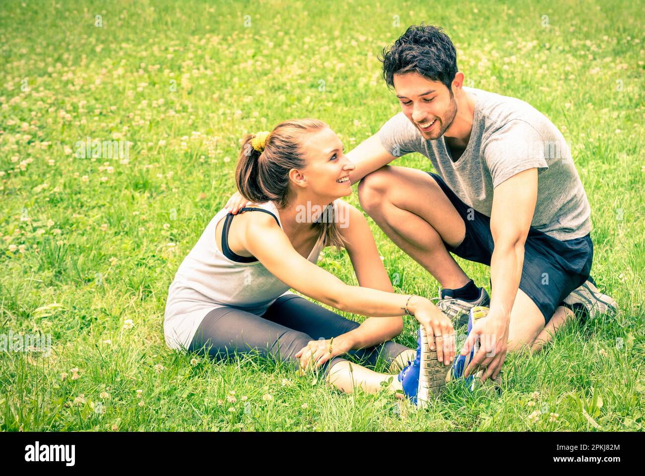 Happy couple training in the park - Young man and woman during summer ...