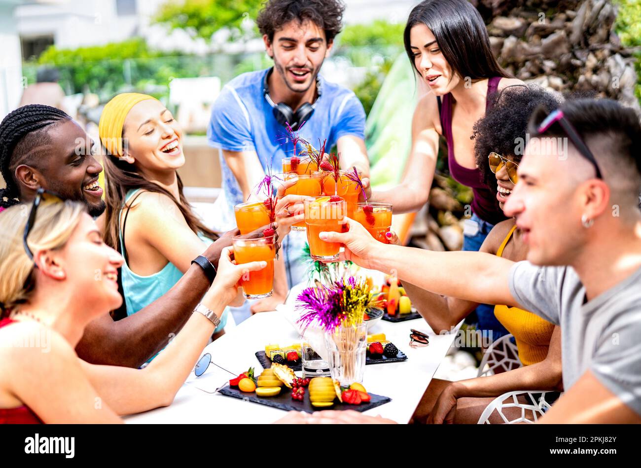 Fancy people drinking cocktails at poolside party - Young friends ...